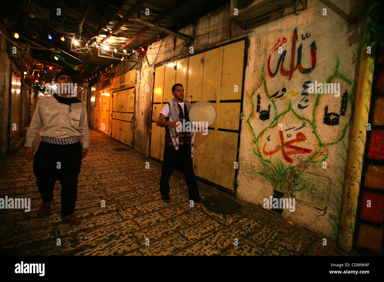 Palestinian youths use a traditional drum to wake up people for their ...