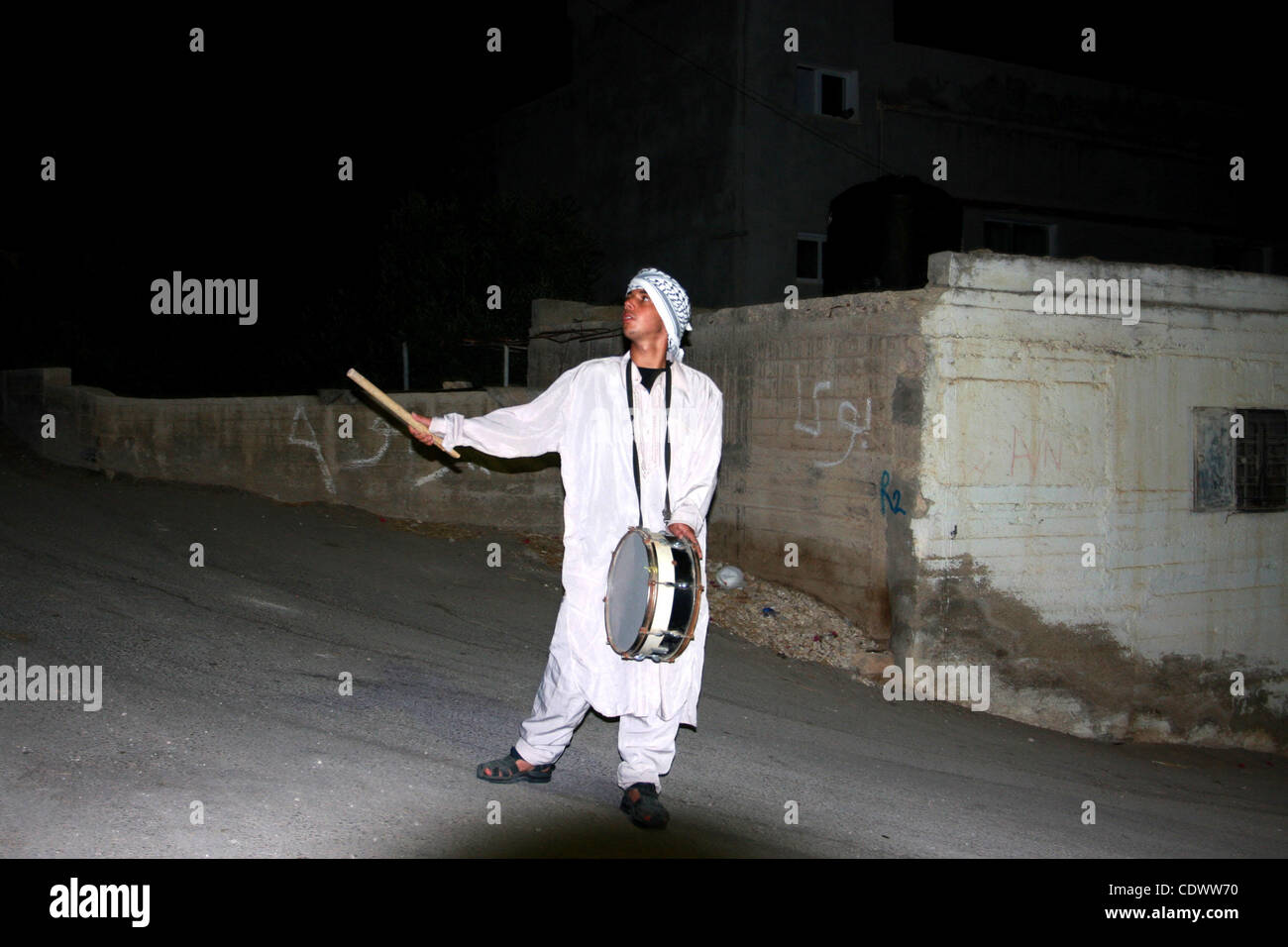 A Palestinian man 'Mesaharaty' uses a traditional drum to wake up ...