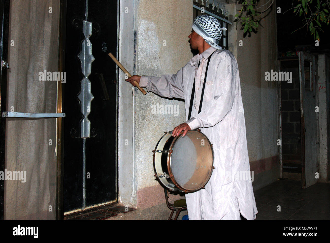 A Palestinian man 'Mesaharaty' uses a traditional drum to wake up ...