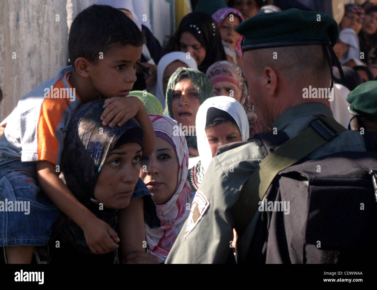 Palestinian Muslims wait at an Israeli checkpoint on the outskirts of ...