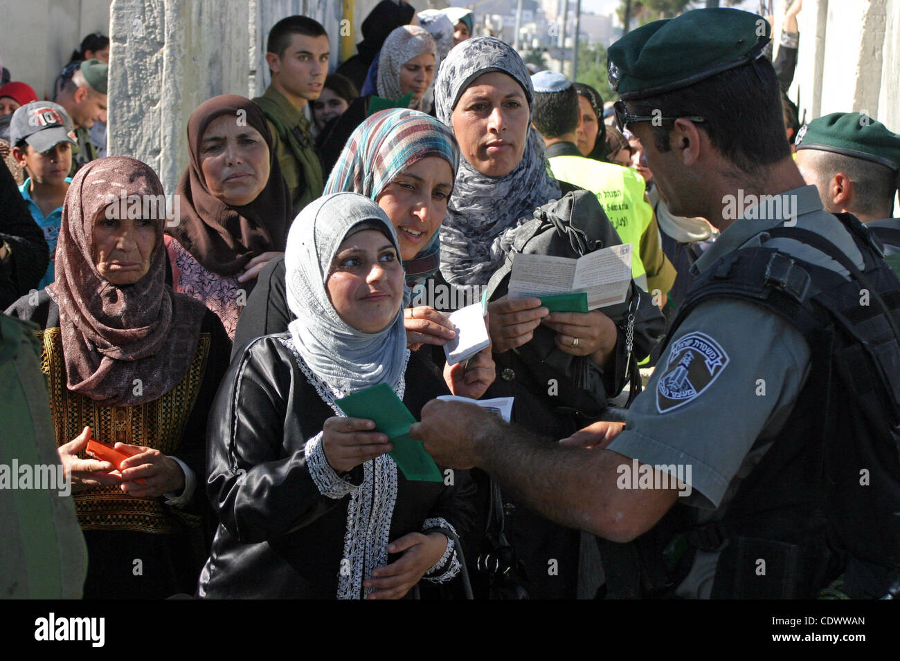 Palestinian Muslims wait at an Israeli checkpoint on the outskirts of ...