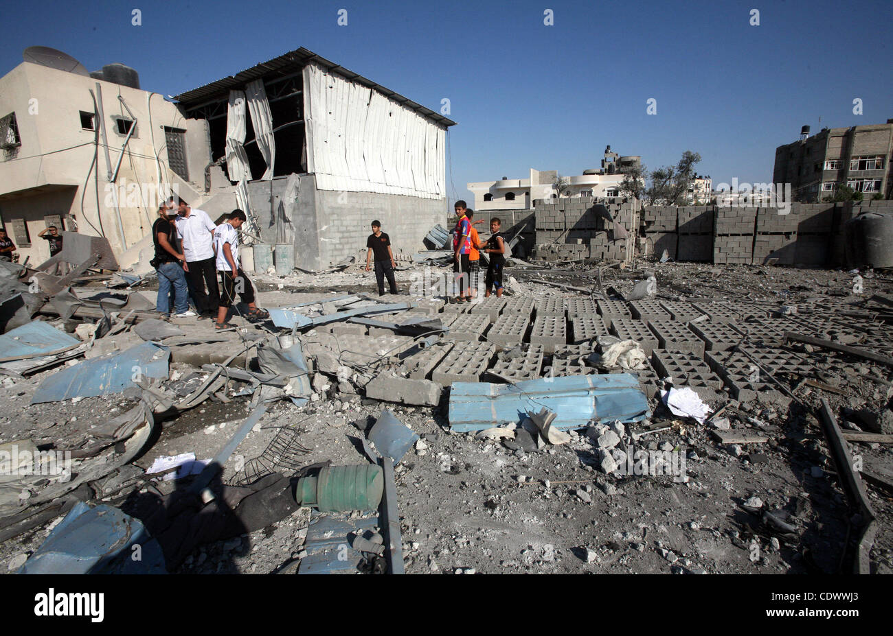 Palestinians inspect the damage at a Hamas training camp following an ...
