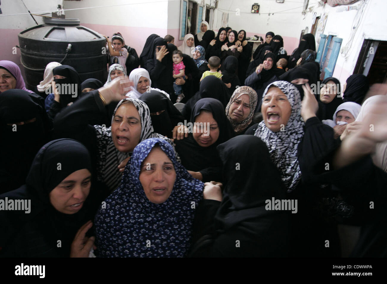 Relatives of Palestinian Hisham Abu Harb mourn during his funeral in ...