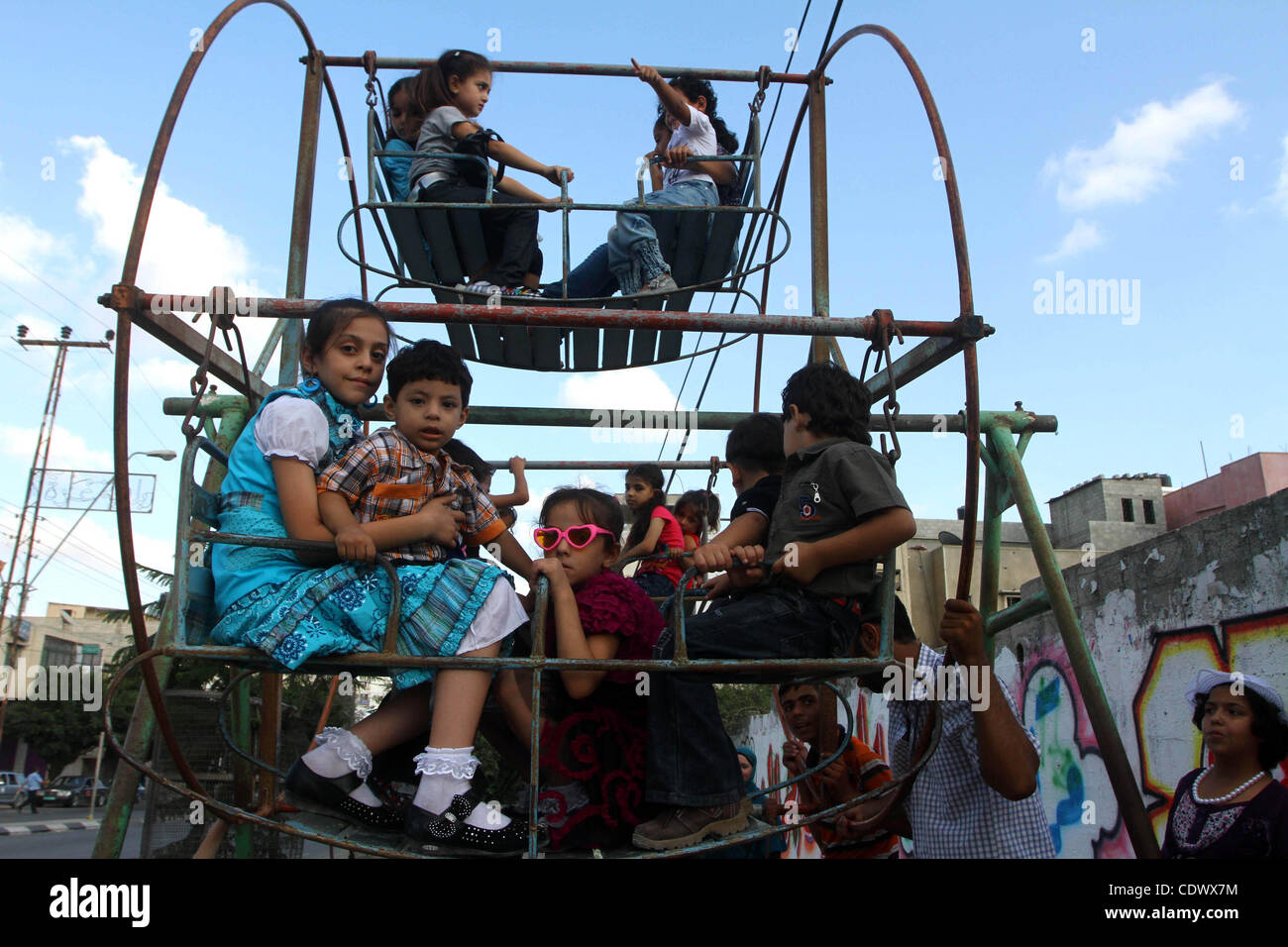 Palestinian children enjoy a ride at an amusement park on the second ...