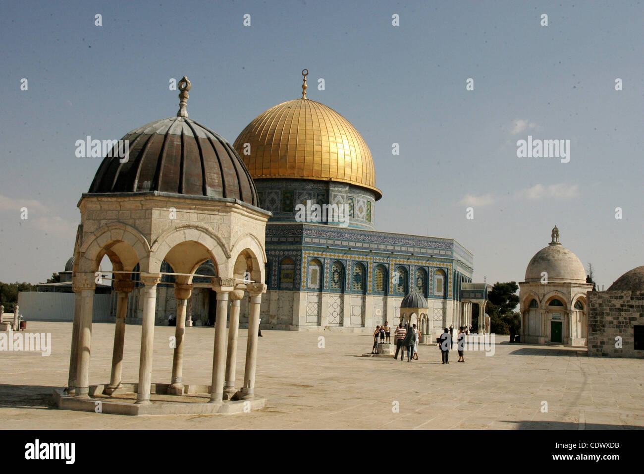 Palestinians walk in front of the Dome of the Rock at the Al-Aqsa ...