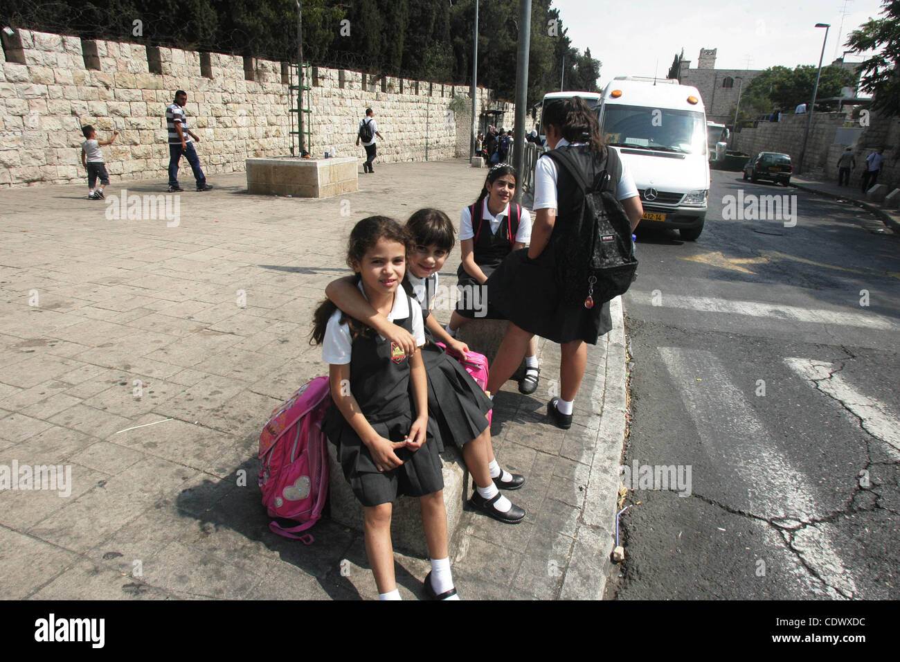 Palestinian students wait in a street after they returned back from ...