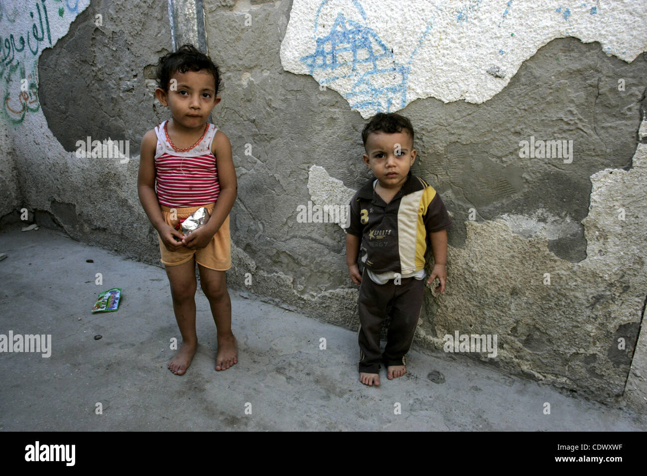 Palestinian children stand in the street in the Rafah Refugee Camp ...