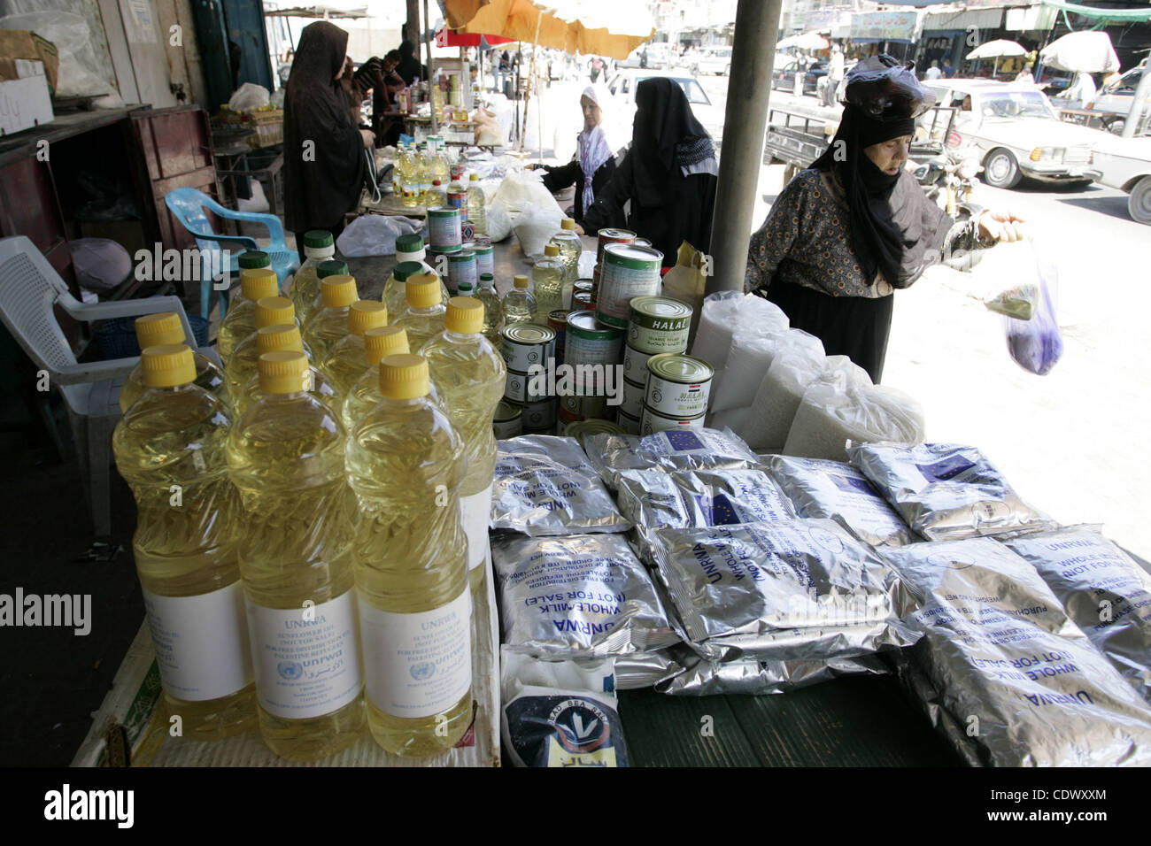 Palestinians receive their food aid from a UN distribution centre in ...