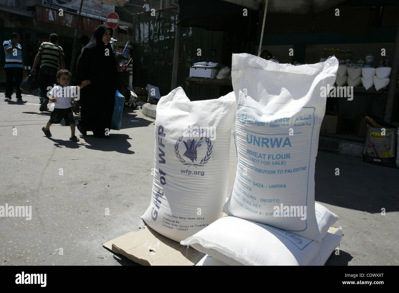 Palestinians receive their food aid from a UN distribution centre in ...