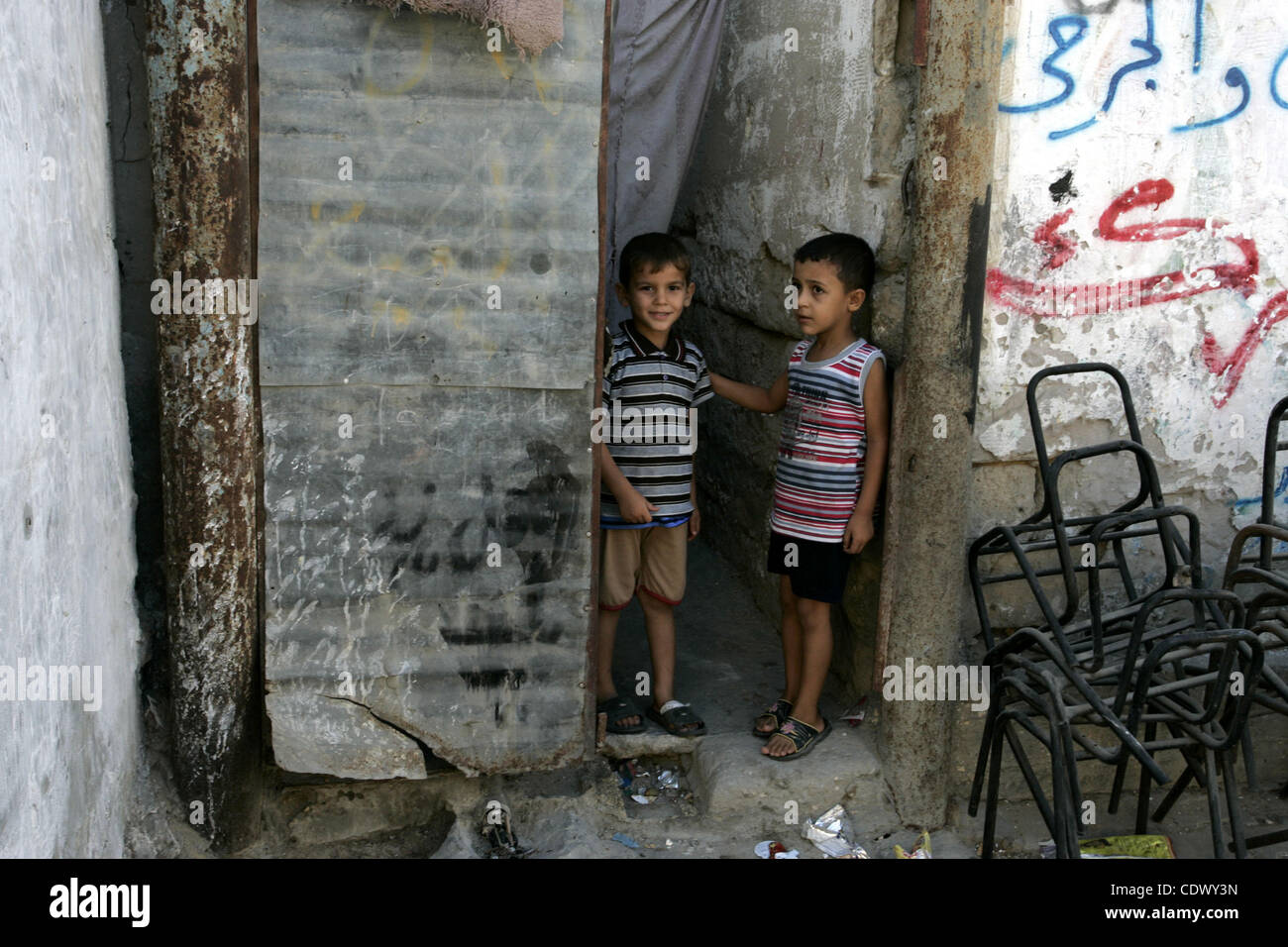 Palestinian children stand outside their house at Rafah refugee camp ...