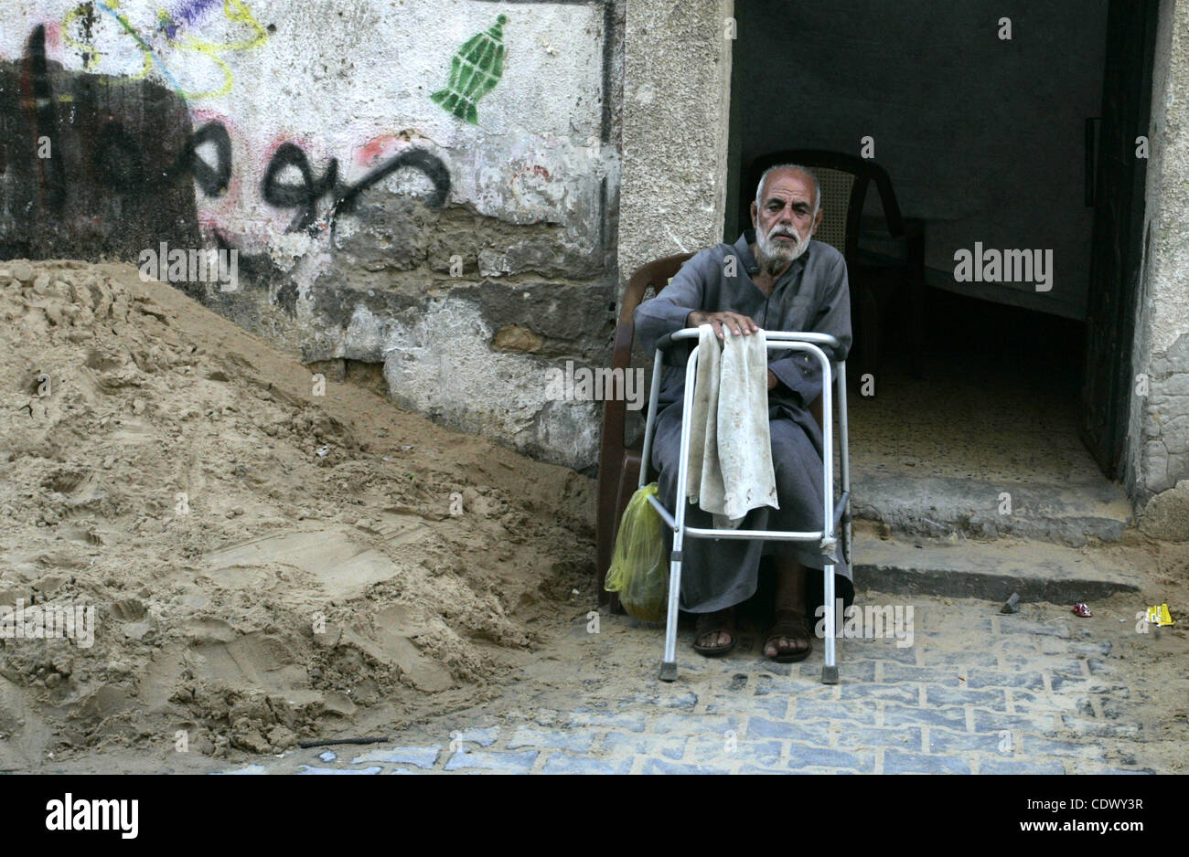 A Palestinian old man sits infront of his home in the Rafah refugee ...