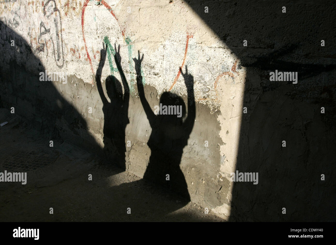 A shadow of Palestinian children display a sign of victory on a wall in ...