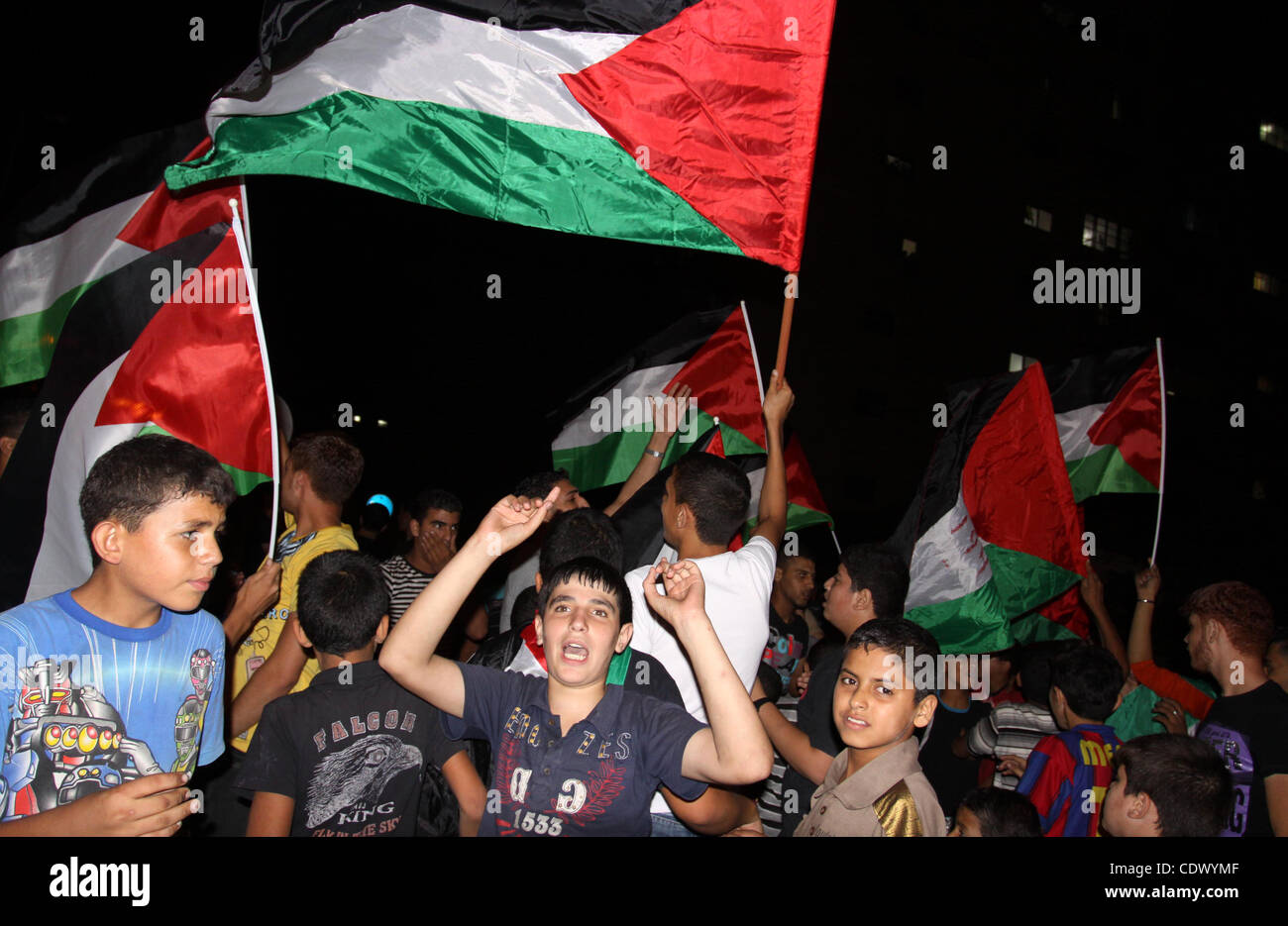 Palestinian Fatah party supporters wave their national flag in support ...