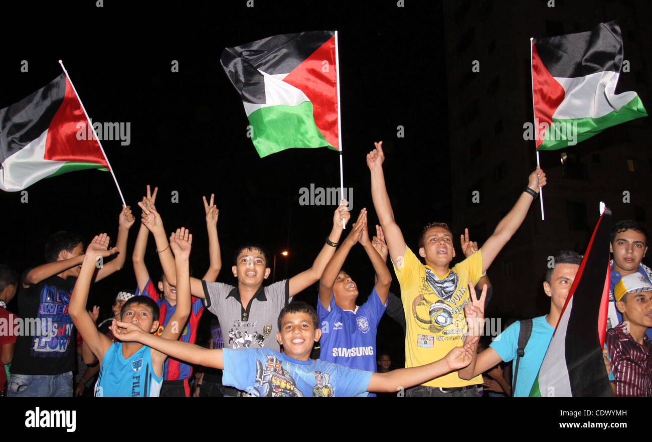 Palestinian Fatah party supporters wave their national flag in support ...