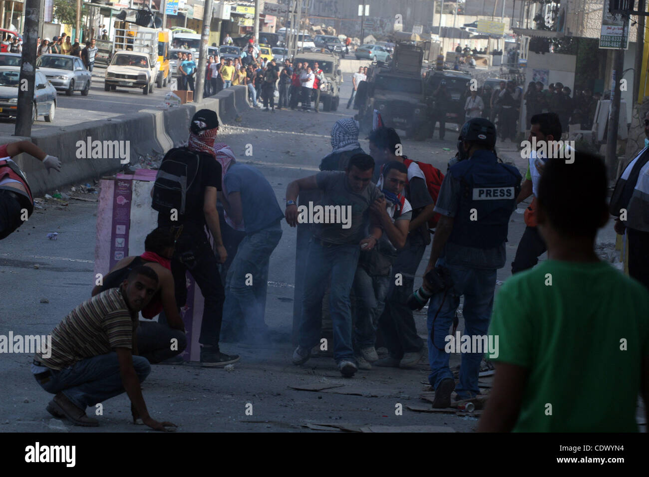 Palestinian men throw stones at Israeli soldiers during riots at the ...