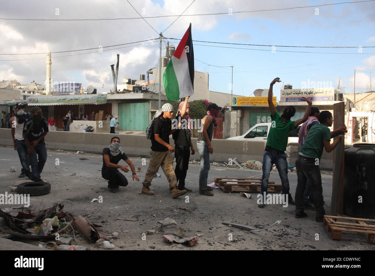 Palestinian men throw stones at Israeli soldiers during riots at the ...