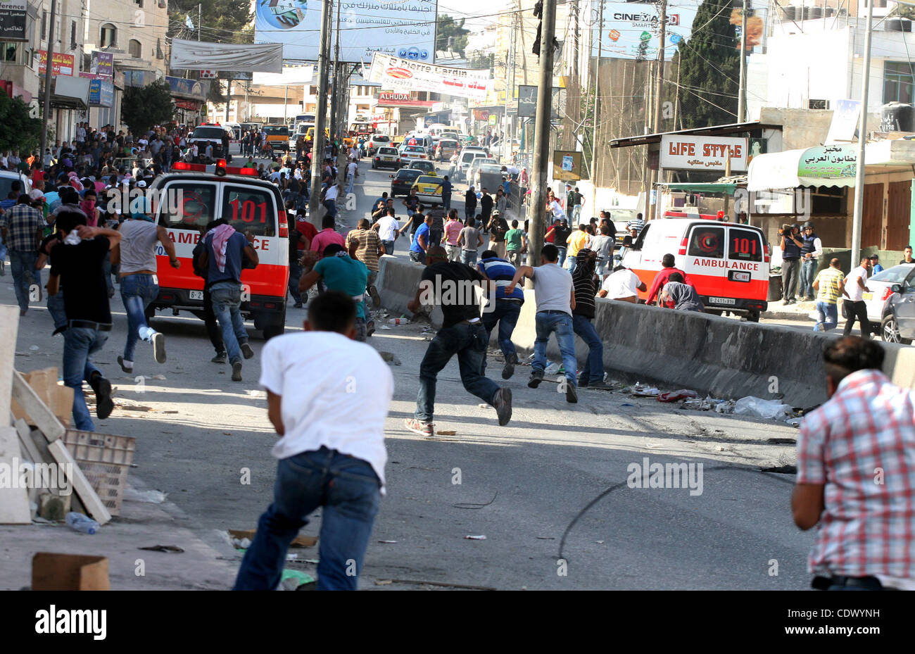 Palestinian men throw stones at Israeli soldiers during riots at the ...