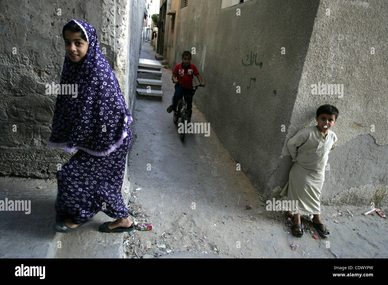 Palestinian children stand outside their houses in Rafah refugee camp ...