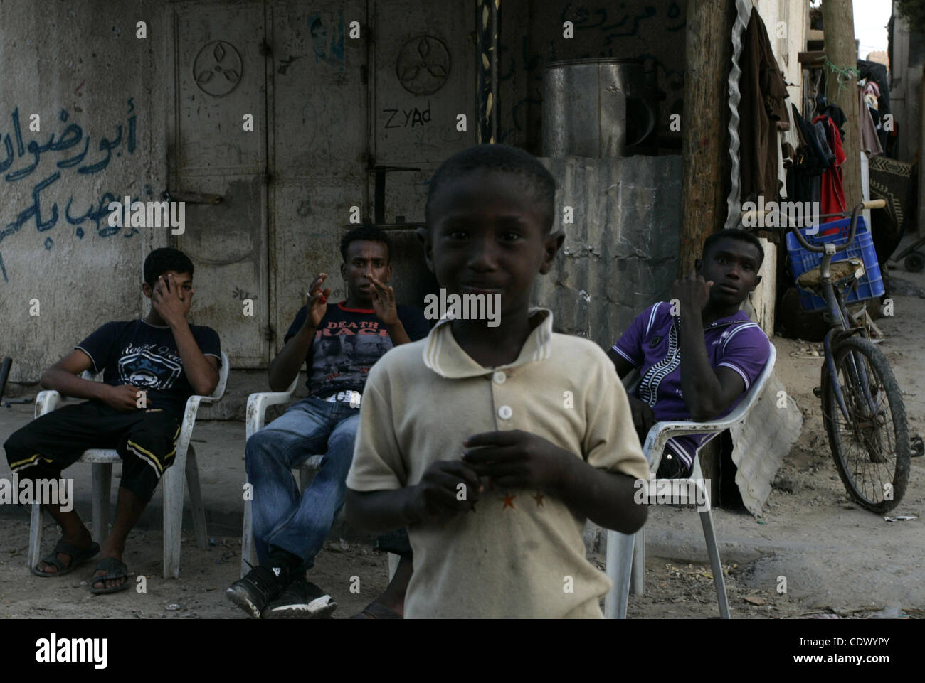Palestinian children sit outside their houses in Rafah refugee camp ...