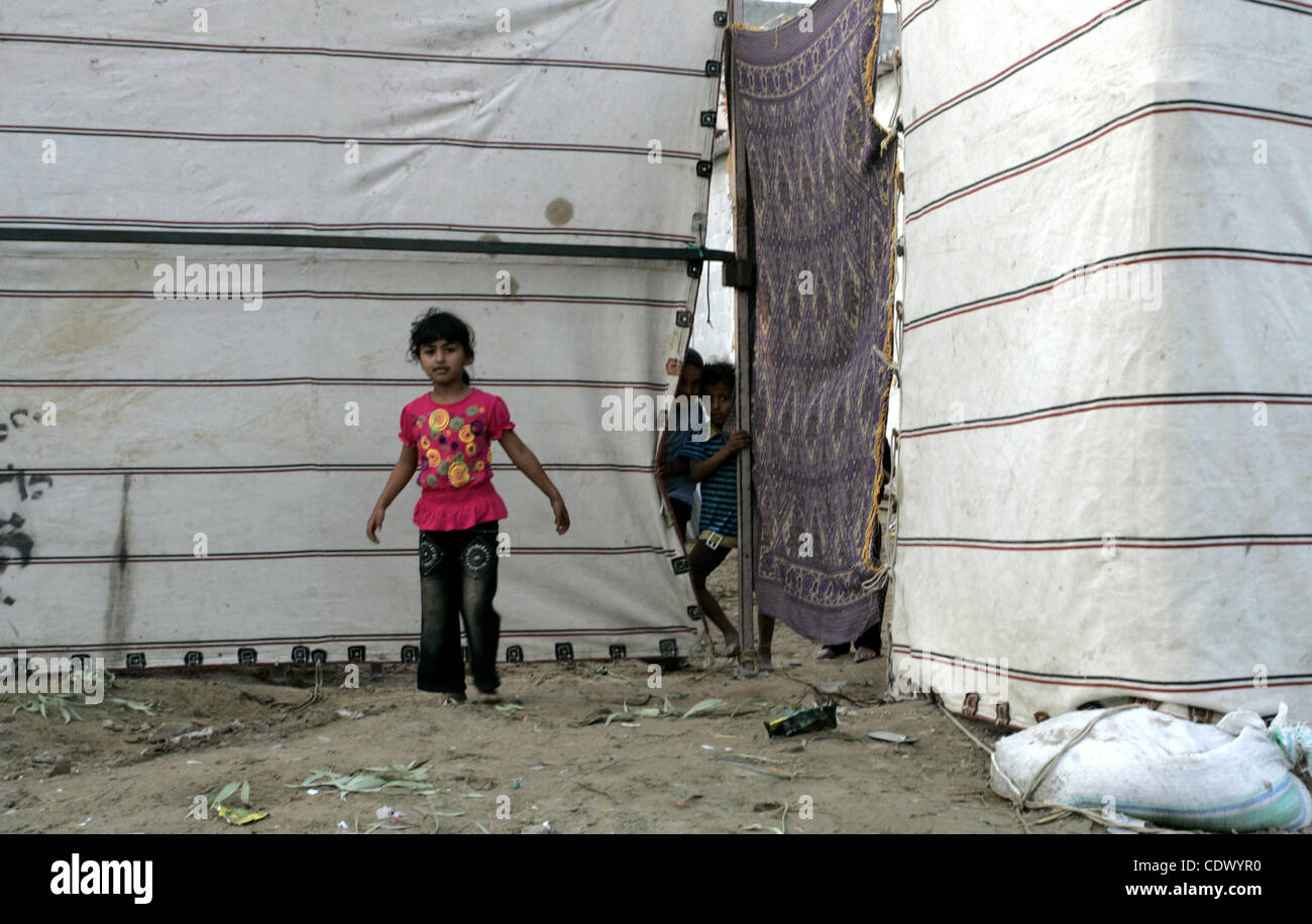 Palestinian children stand outside their houses in Rafah refugee camp ...
