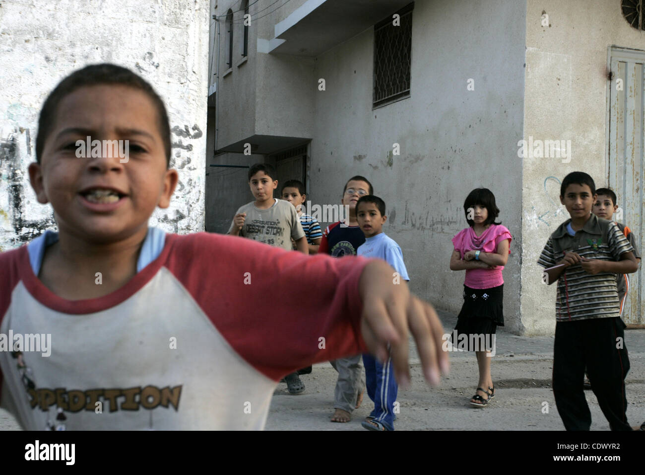 Palestinian children play outside their houses in Rafah refugee camp ...