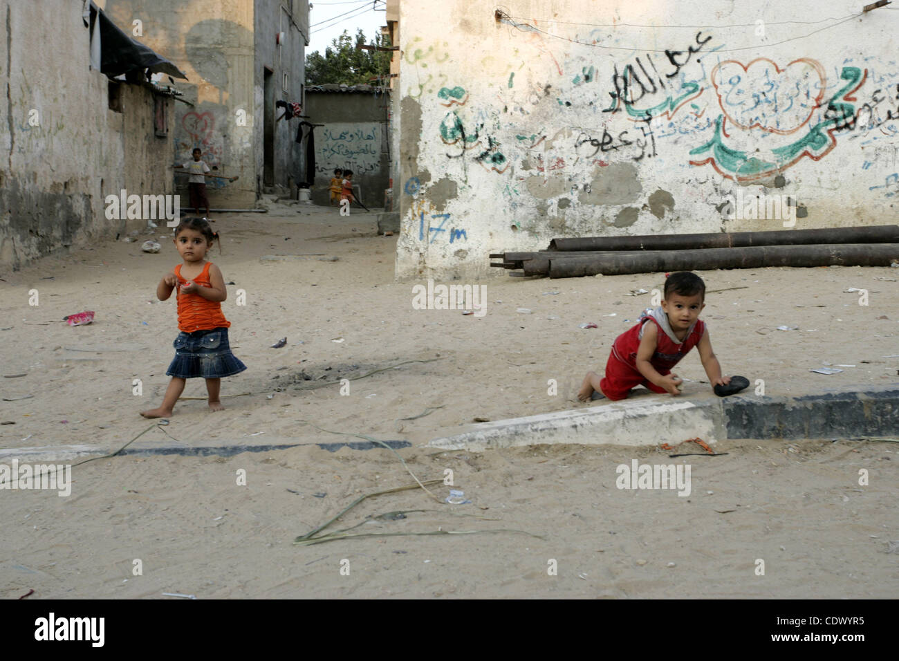 Palestinian children play outside their houses in Rafah refugee camp ...
