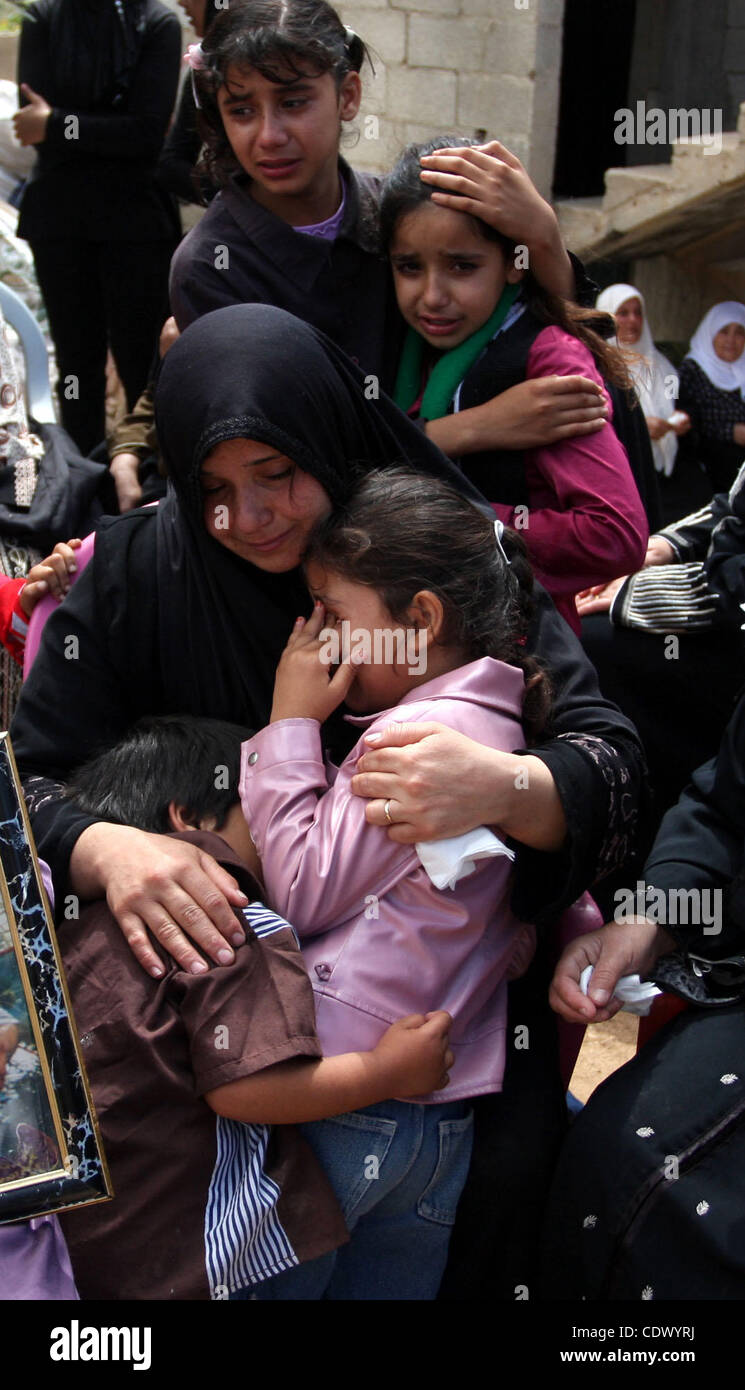 Palestinian Samir Badran, center, embraces her children during the ...