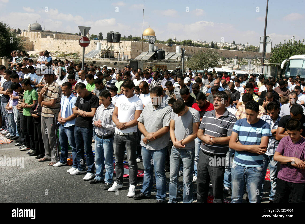 Palestinian Muslims attend Friday prayers at a street in the ...
