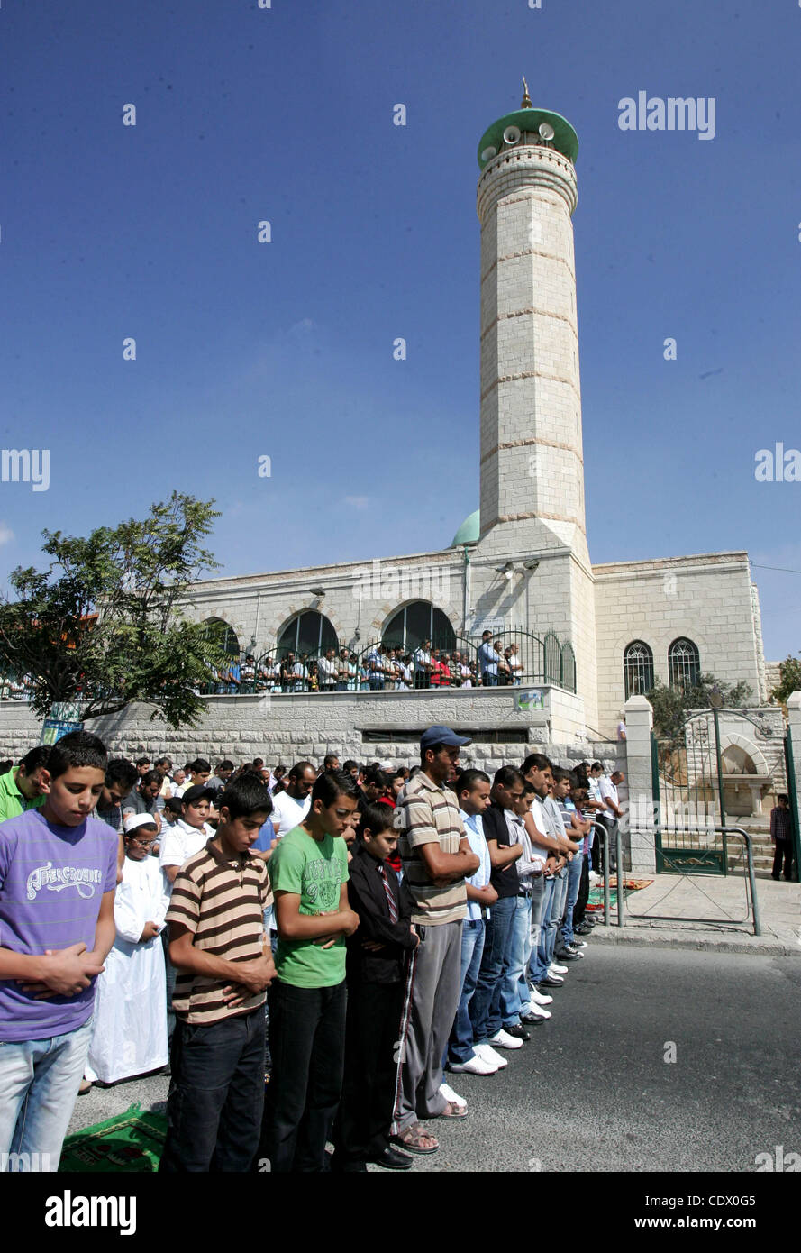 Palestinian Muslims attend Friday prayers at a street in the ...