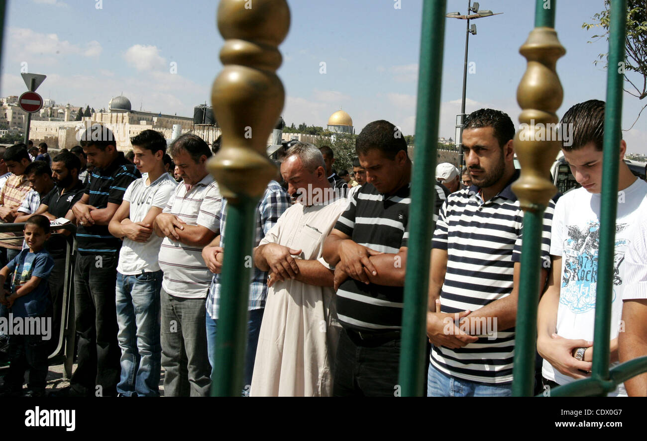 Palestinian Muslims attend Friday prayers at a street in the ...