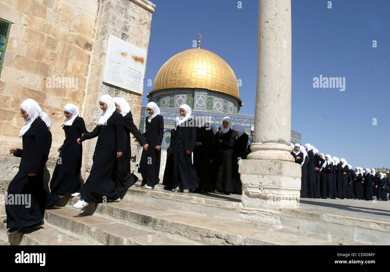 Palestinian schoolgirls walk in front of the Dome of the Rock at Al ...