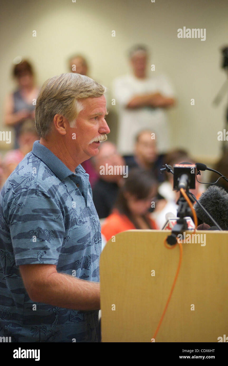 Kelly's father, Ron Thomas, at the podium. Crowds gather in protest of ...