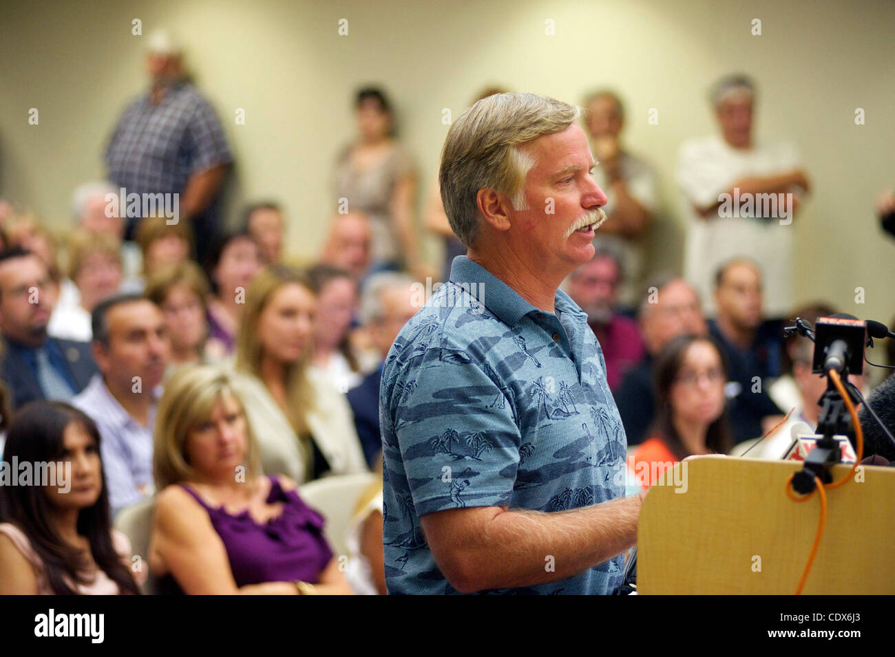 Kelly's father, Ron Thomas, at the podium. Crowds gather in protest of ...