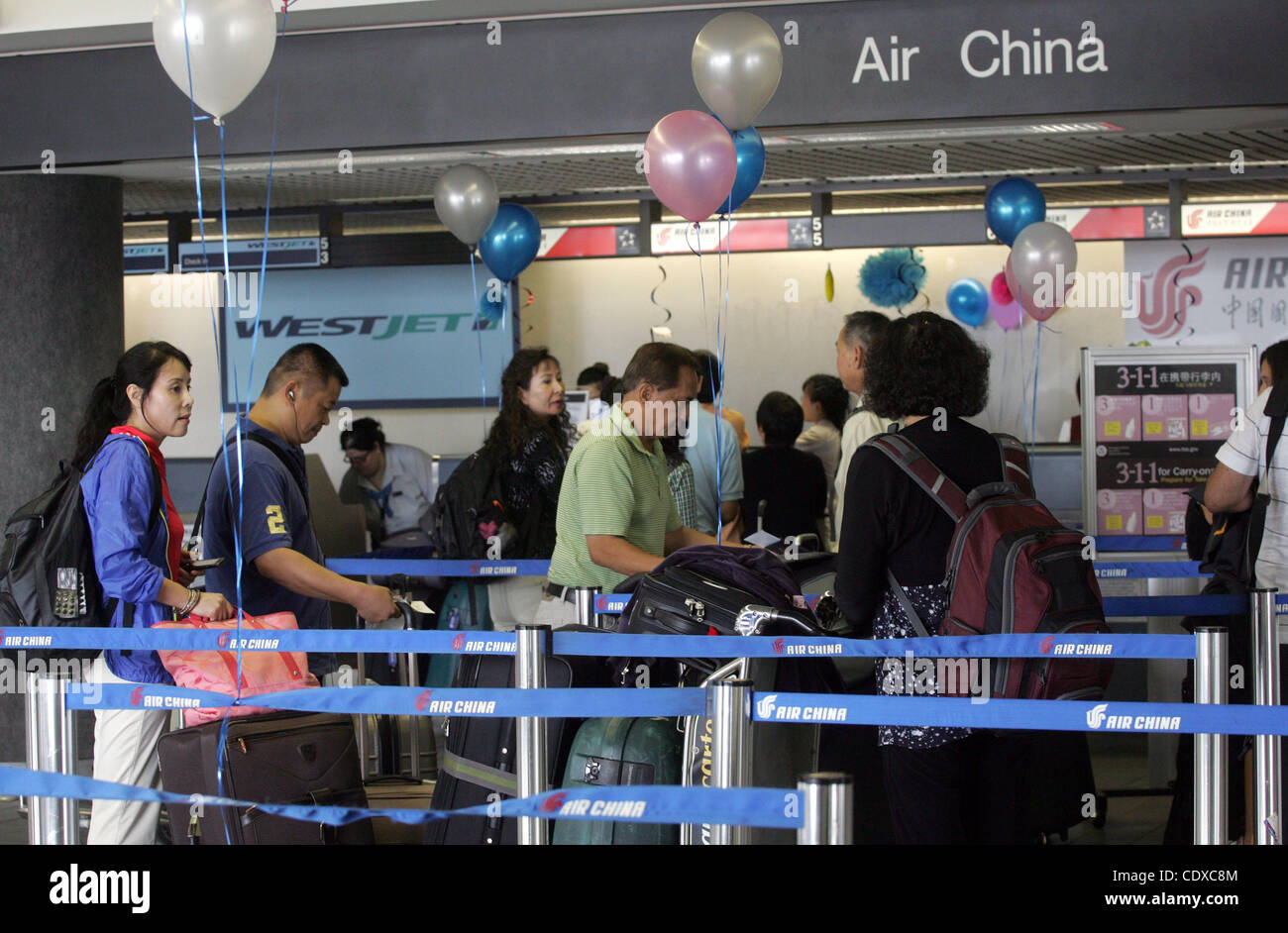 Passengers line for check in at the counter of Air China on Thursday in ...
