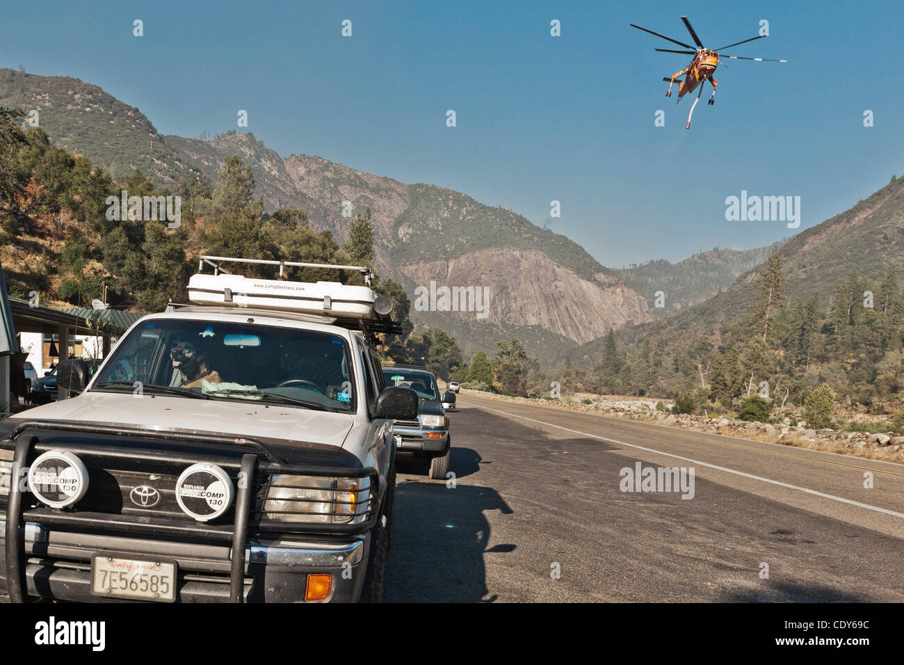 A Sikorski firefighting helicopter heads toward the fire's front at the ...