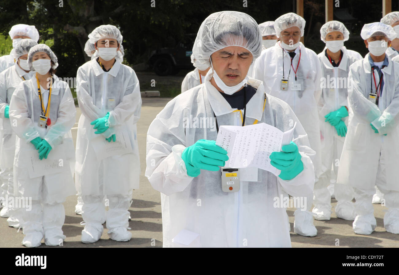July 24, 2011 - Okuma, Japan - Residents of Okuma-cho prays during a ...