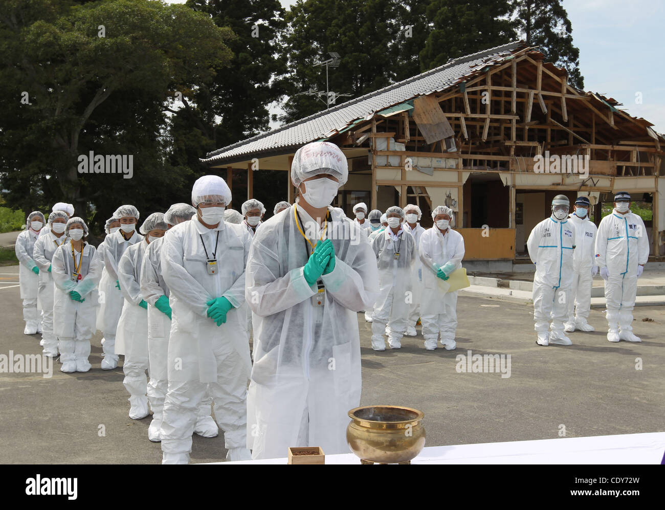 July 24, 2011 - Okuma, Japan - Residents of Okuma-cho prays during a ...