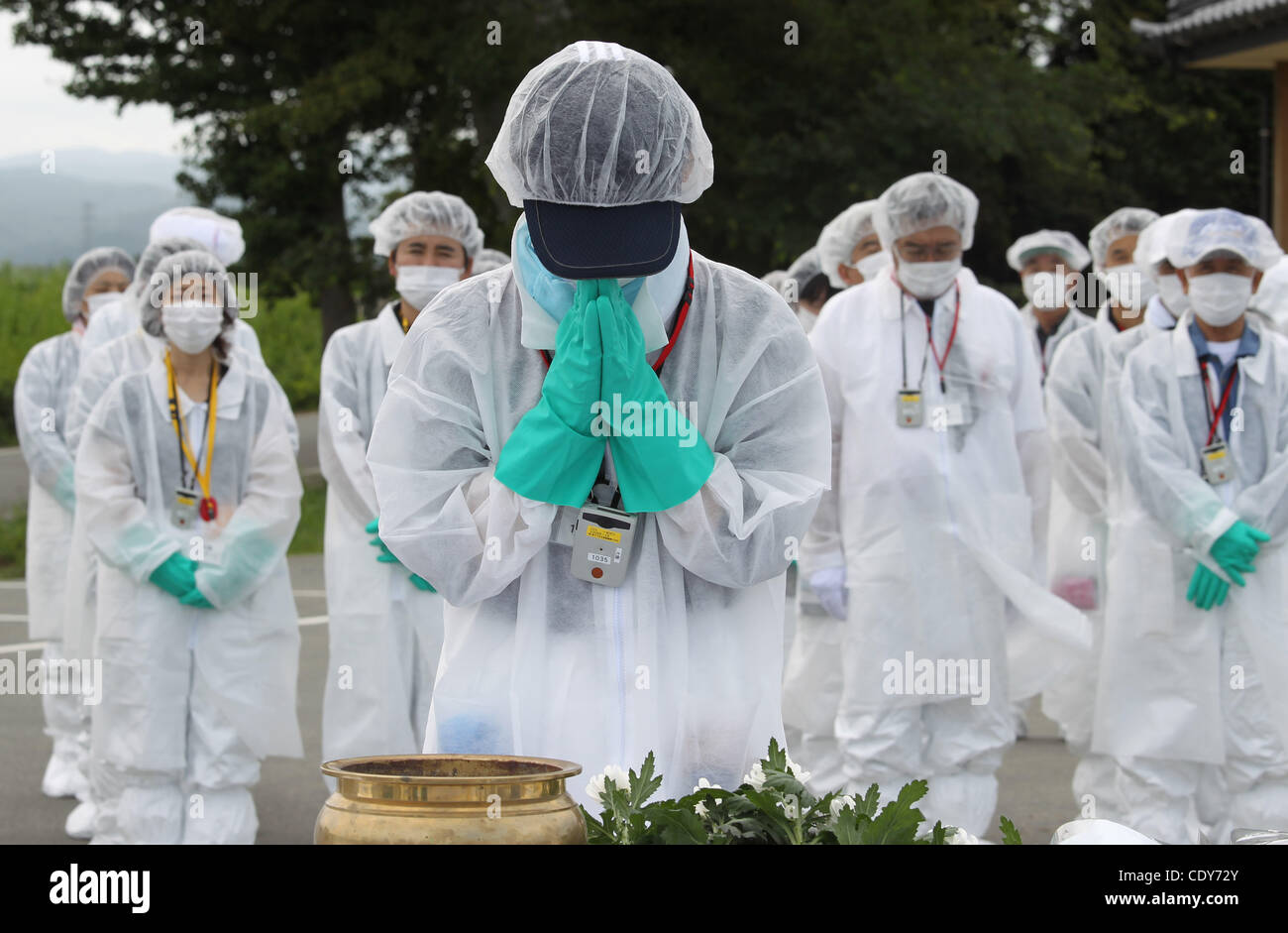July 24, 2011 - Okuma, Japan - Residents of Okuma-cho prays during a ...