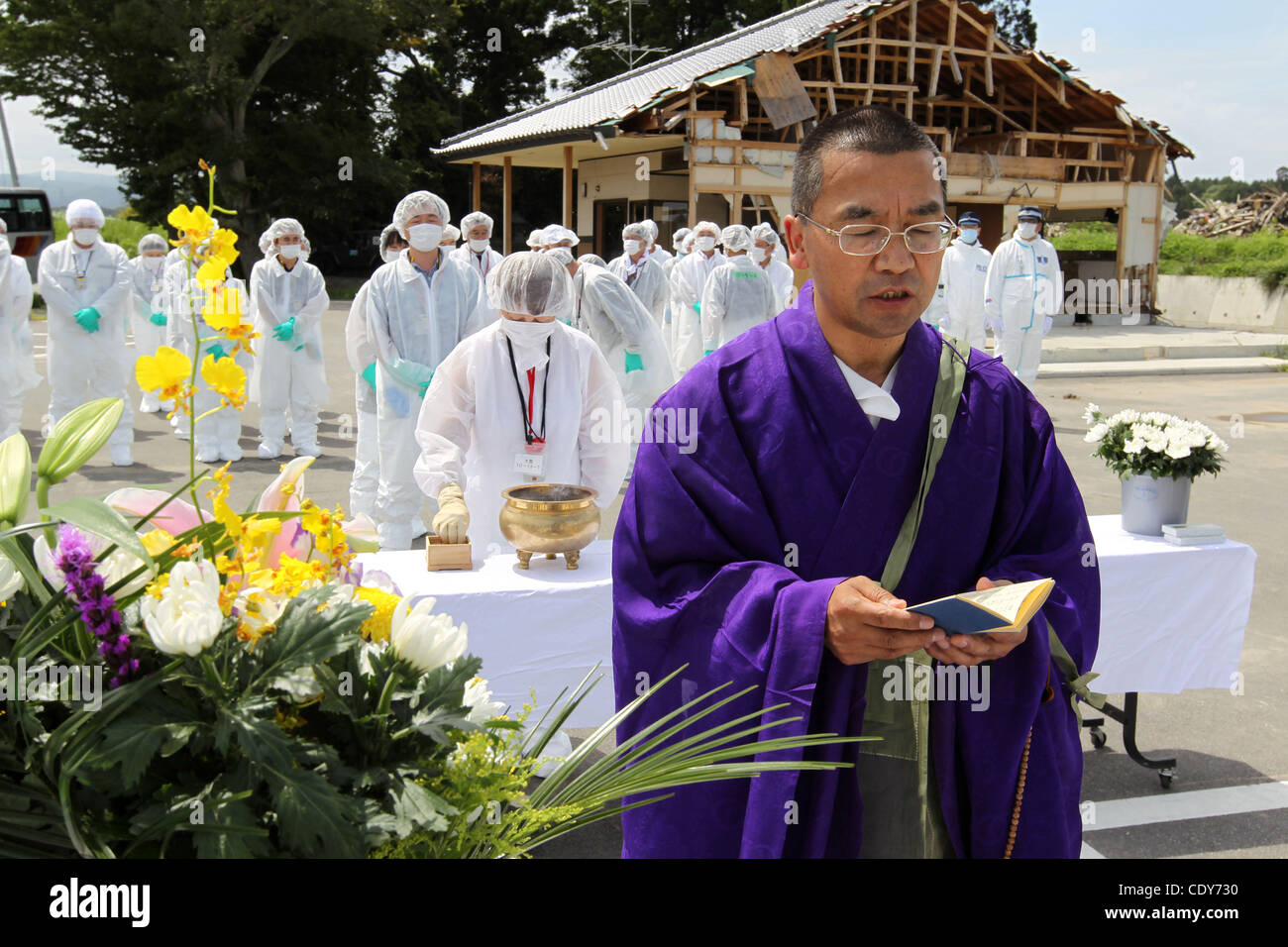 July 24, 2011 - Okuma, Japan - Residents of Okuma-cho prays during a ...