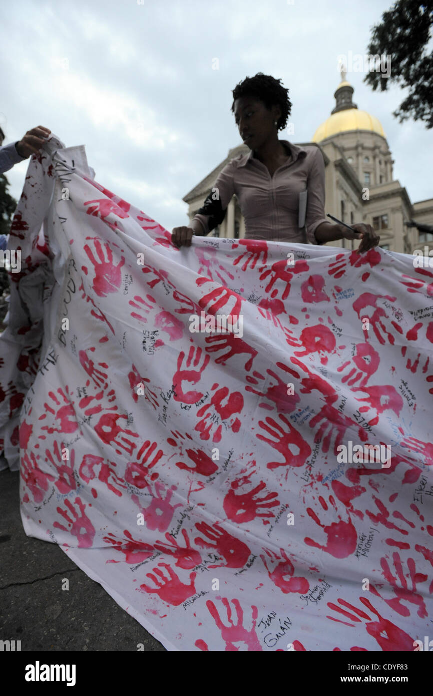 Sept. 20, 2011 - Atlanta, GA, U.S. - A woman spreads out protest sheets ...