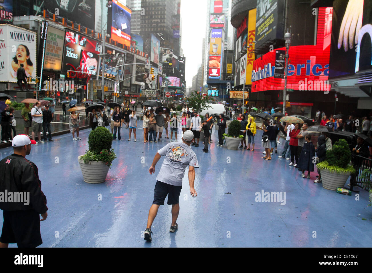 Ed Pelaez in a largely deserted Times Square pitching to a child. He ...