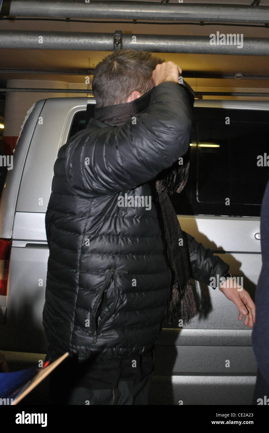 Robbie Williams of Take That hiding behind his scarf whilst arriving at ...