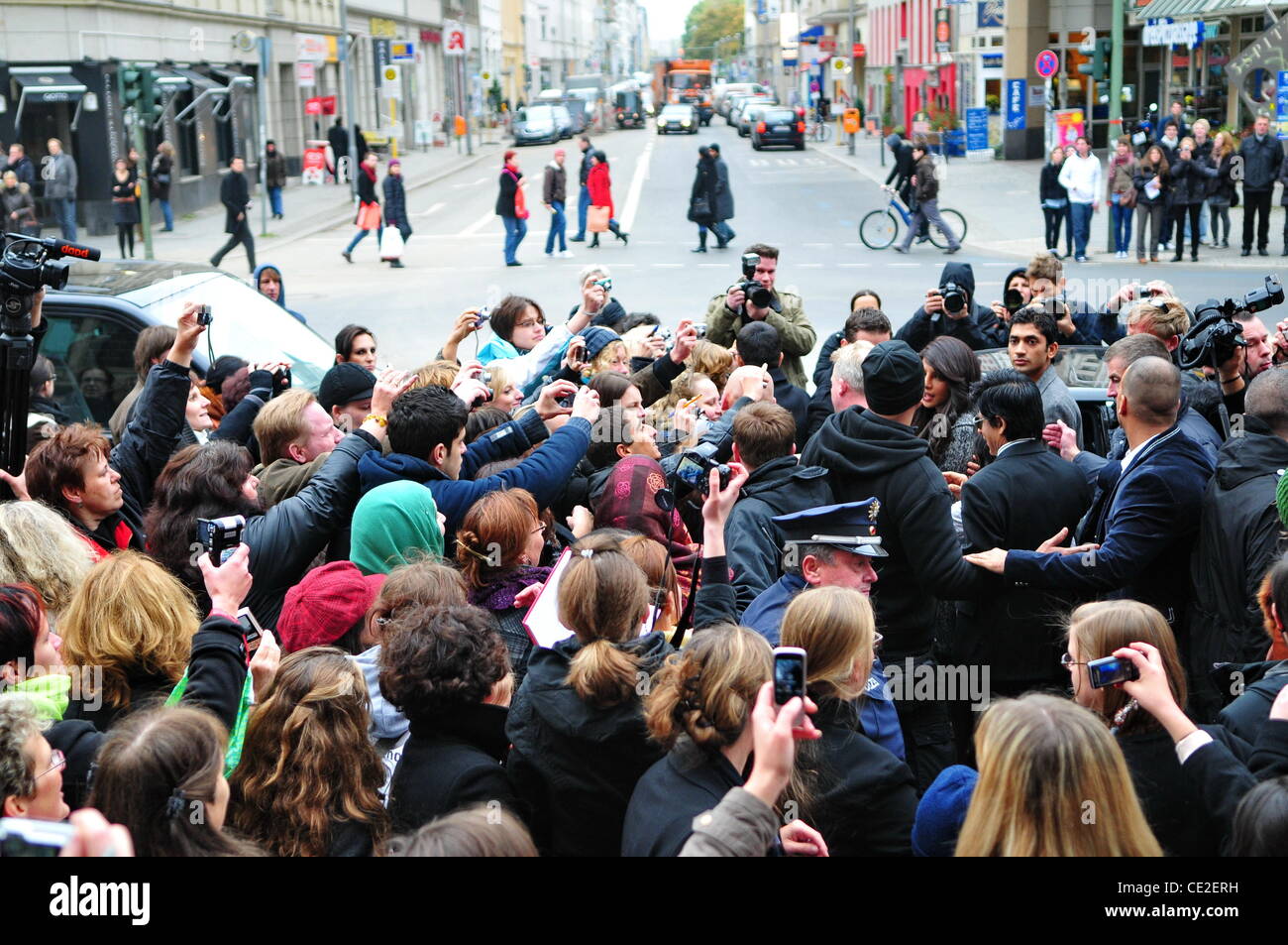 Shahrukh Khan trying to find a way through the crowd whilst leaving the ...
