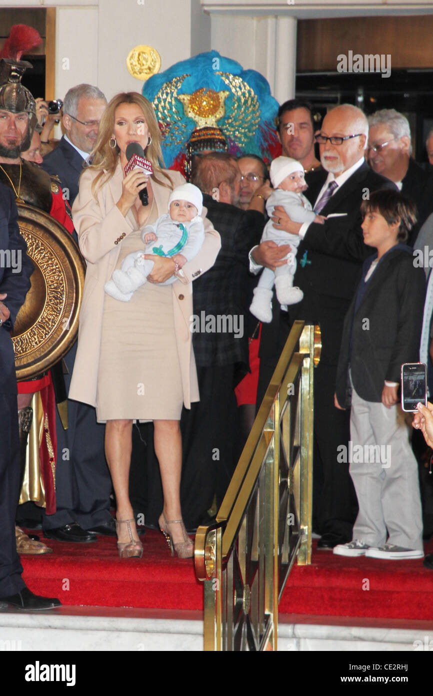 Singer Celine Dion holds her son Nelson Angelil next to her husband and ...