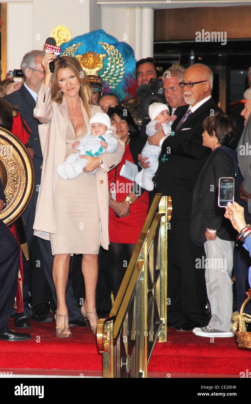 Singer Celine Dion holds her son Nelson Angelil next to her husband and ...