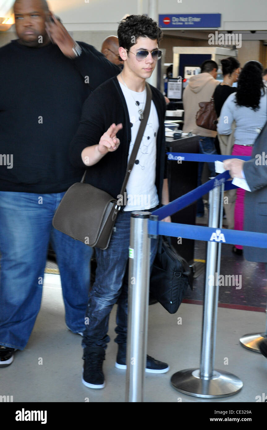 Nick Jonas passes through airport security as he arrives a LAX. Los ...