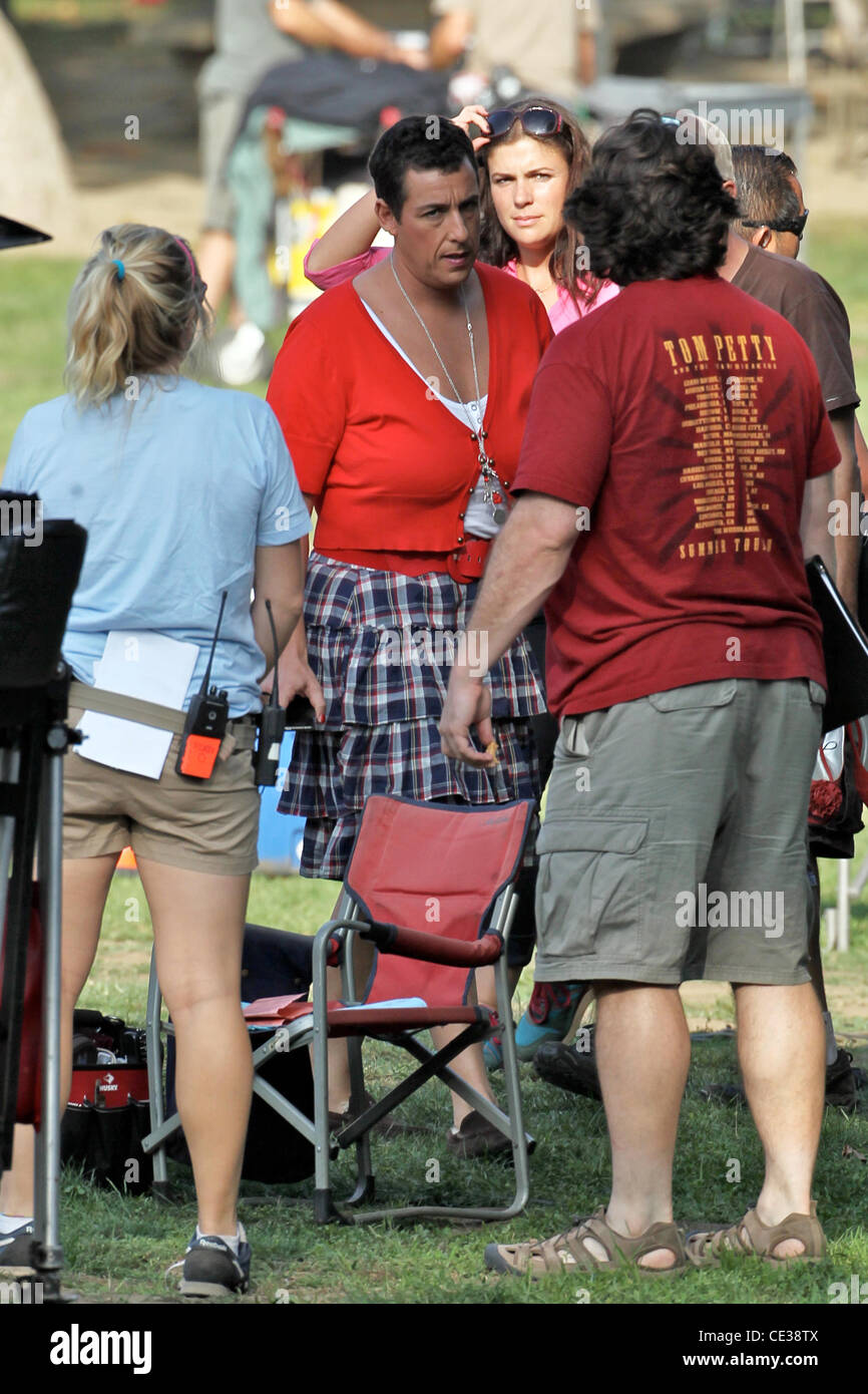 Adam Sandler dressed as a woman in a red cardigan and skirt, on the ...