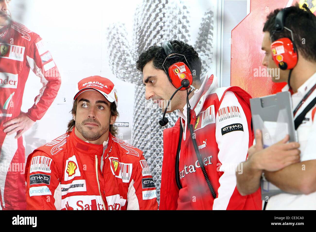 Ferrari Formula One driver Fernando Alonso jumps on the podium as he ...