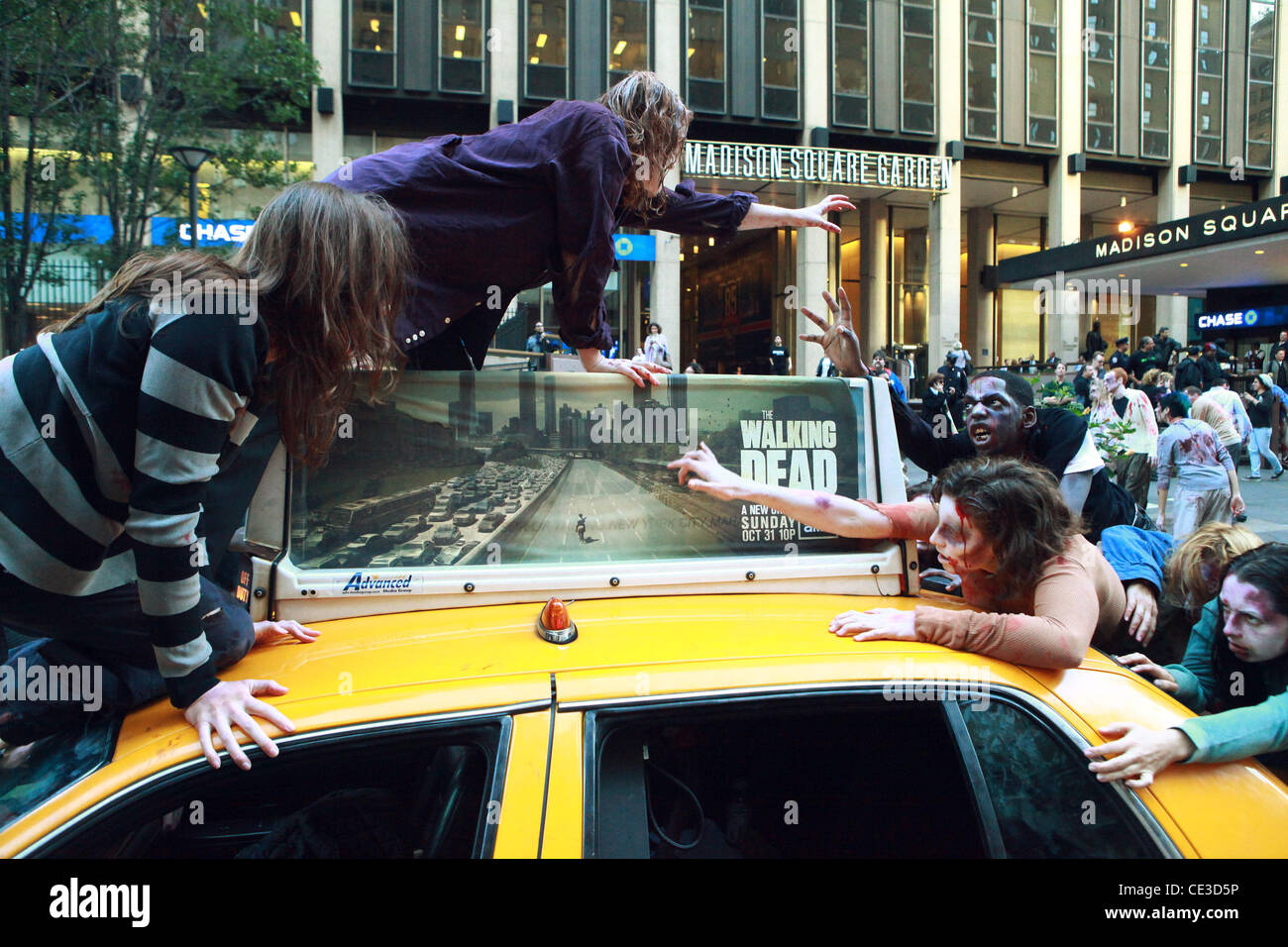 Zombies swarm commuters at Penn Station in anticipation of the premiere ...