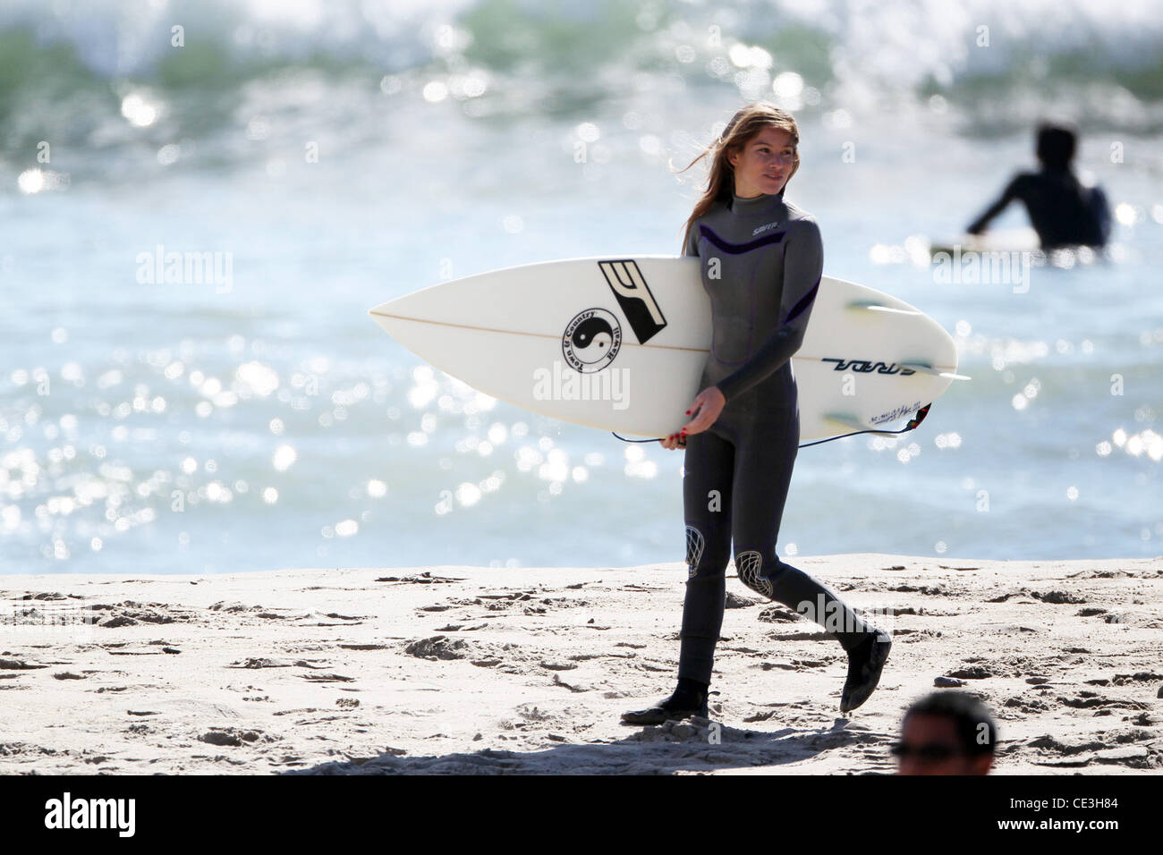 Cast members of the television show '90210' film a beach scene with ...
